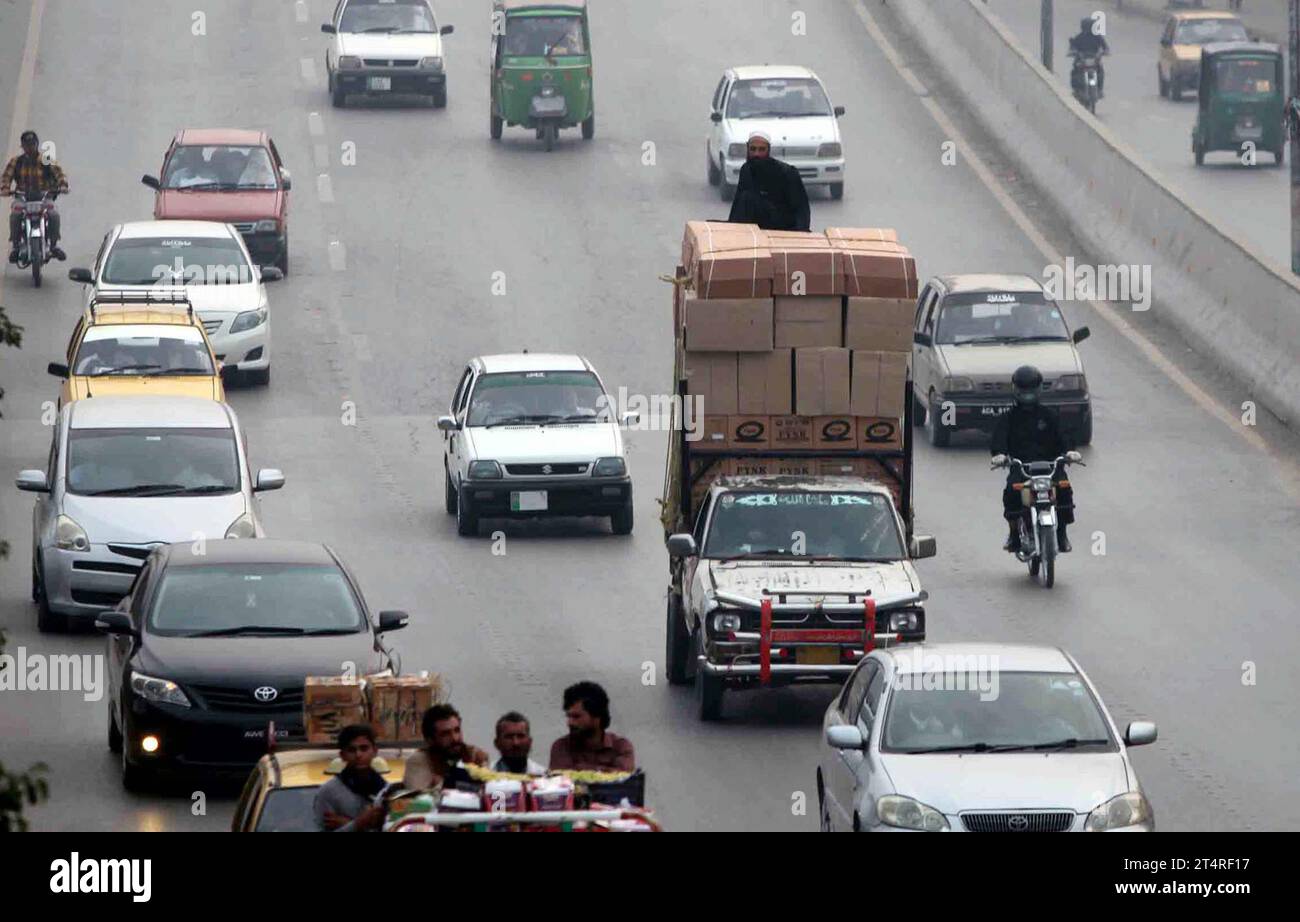 An overloaded vehicle passing through the road violating the traffic ...
