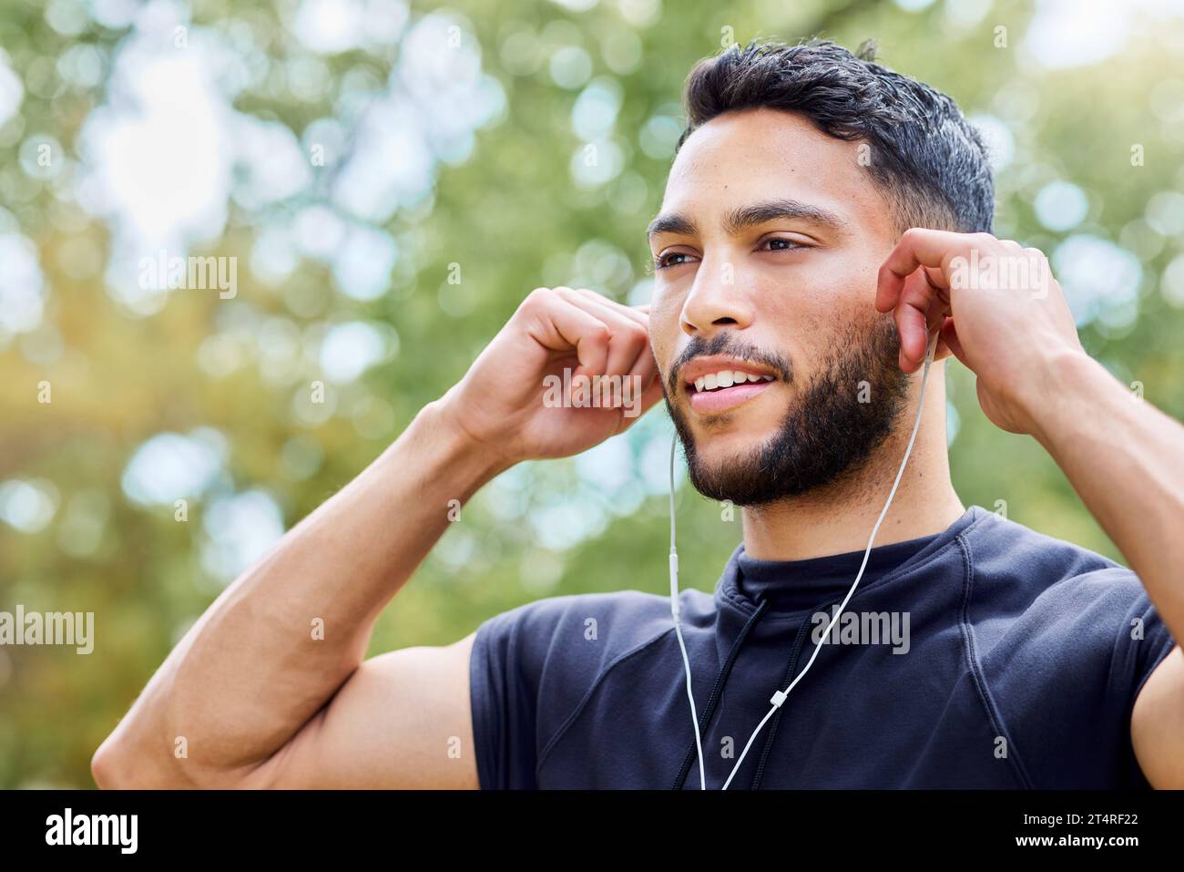 Music can elevate your mood and motivate you. a sporty young man ...