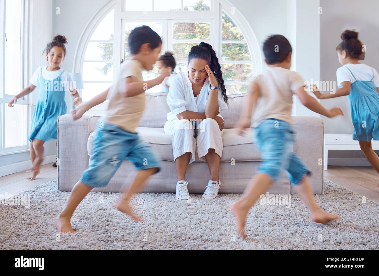 a mixed race single mother looking stressed at home on the while her ...