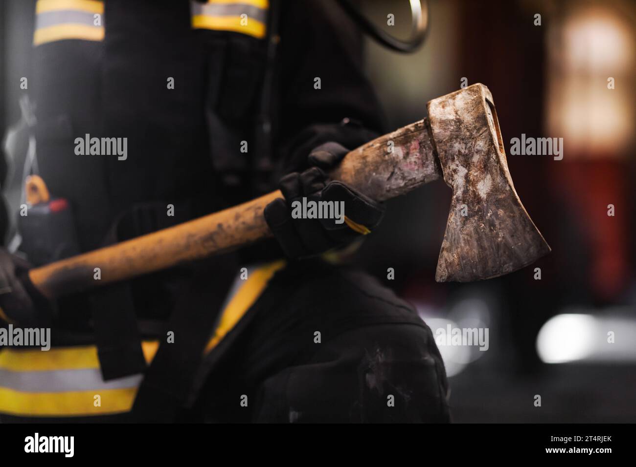Female firefighter with full equipment holding an axe Stock Photo - Alamy