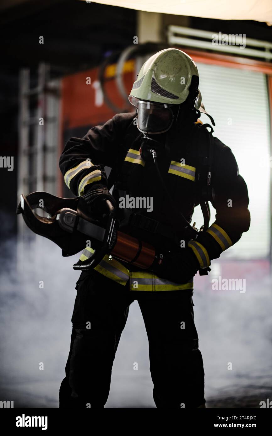 Fireman portrait wearing full equipment with oxygen mask and power ...
