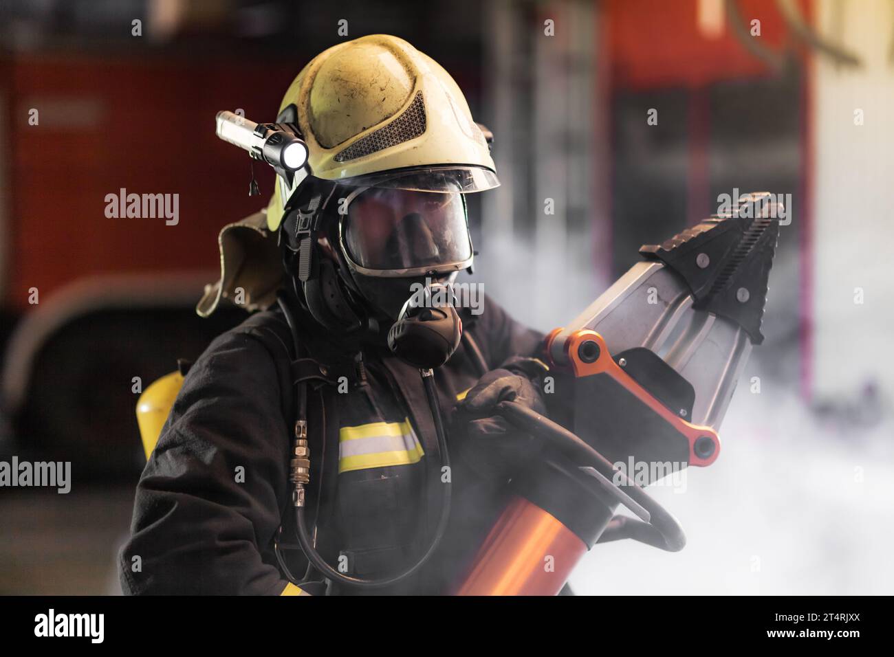 Fireman portrait wearing full equipment and oxygen mask. Firefighter ...