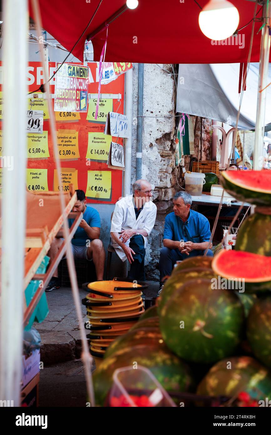 Sicily, Italy - June 22, 2022: Men sitting in the market of palermo ...