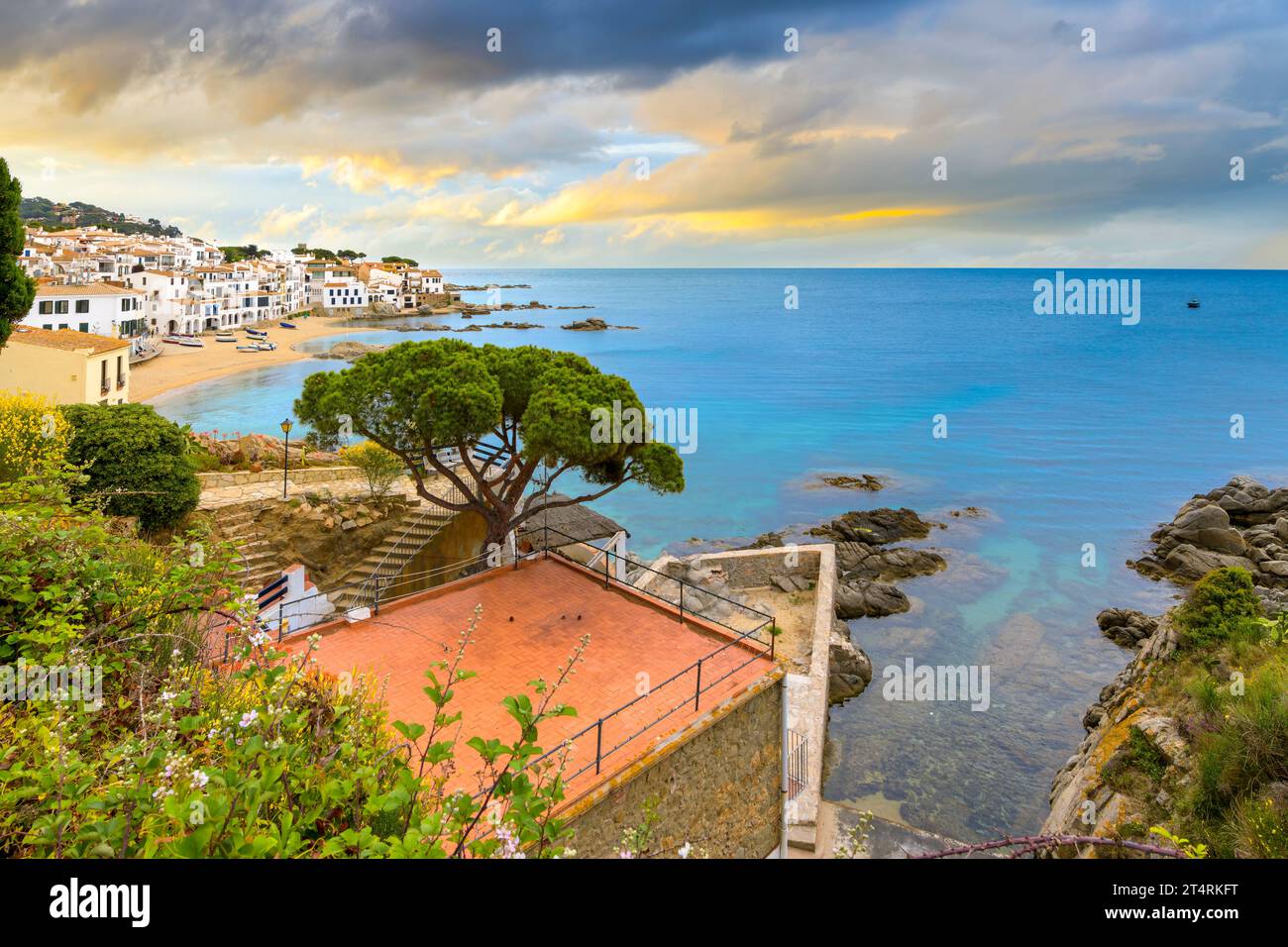 The rocky coast, sandy beach and whitewashed village at the fishing ...