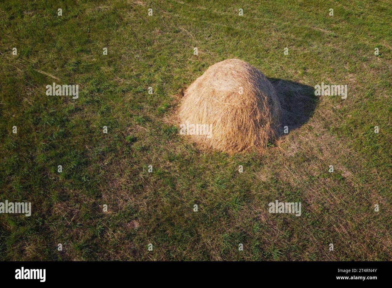 Haystack in a farm field on a warm summer day, top view. Landscape from ...