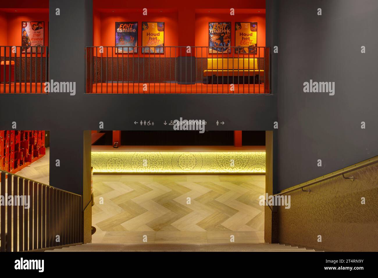 View down stairs to cloakroom with backlit yellow glass panel, with ...