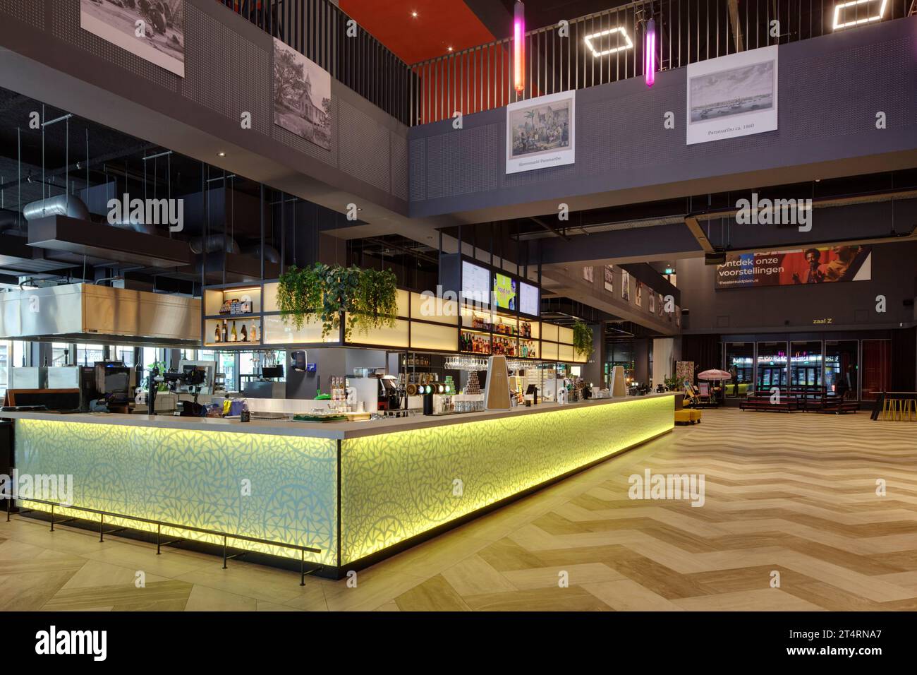 Counter of bar in foyer, with backlit yellow glass panel, with foyer ...