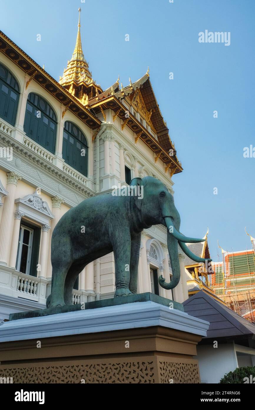 In front of a splendidly adorned building, an impressive elephant ...