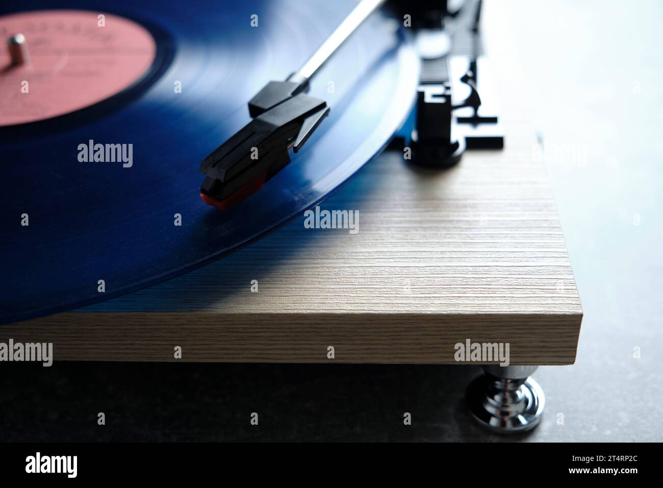 Classic vinyl record player closeup with contoured daylight from window ...