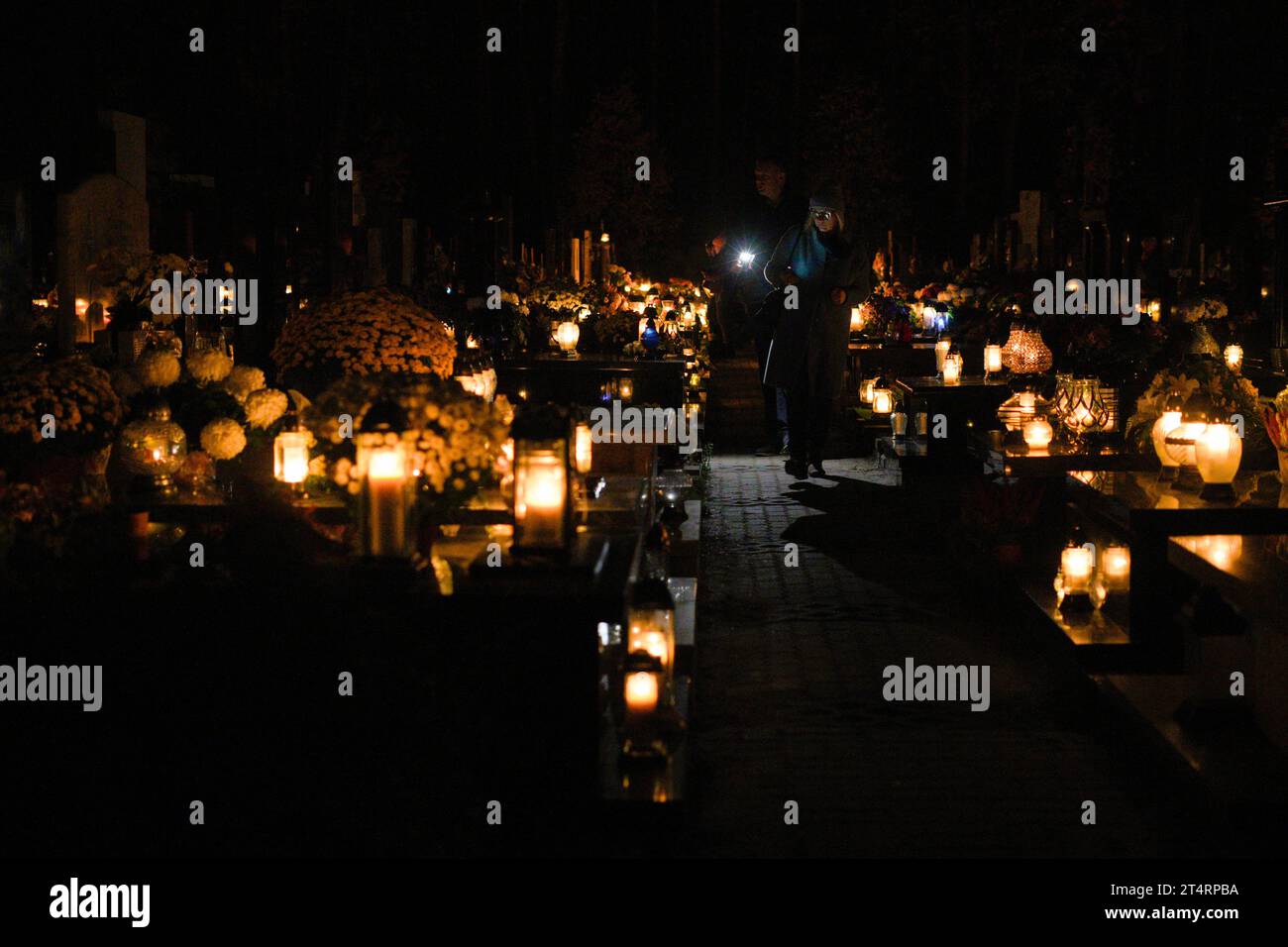 Warsaw, Poland. 01st Nov, 2023. People are seen visiting graves at a ...