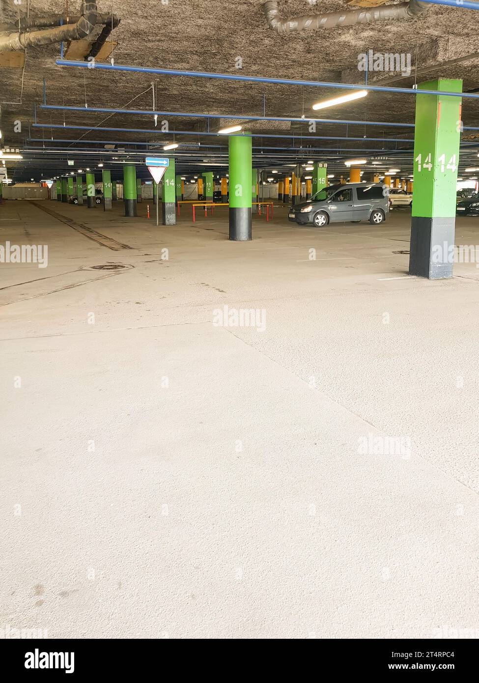 Underground Parking with poles with markings for cars in the shopping ...