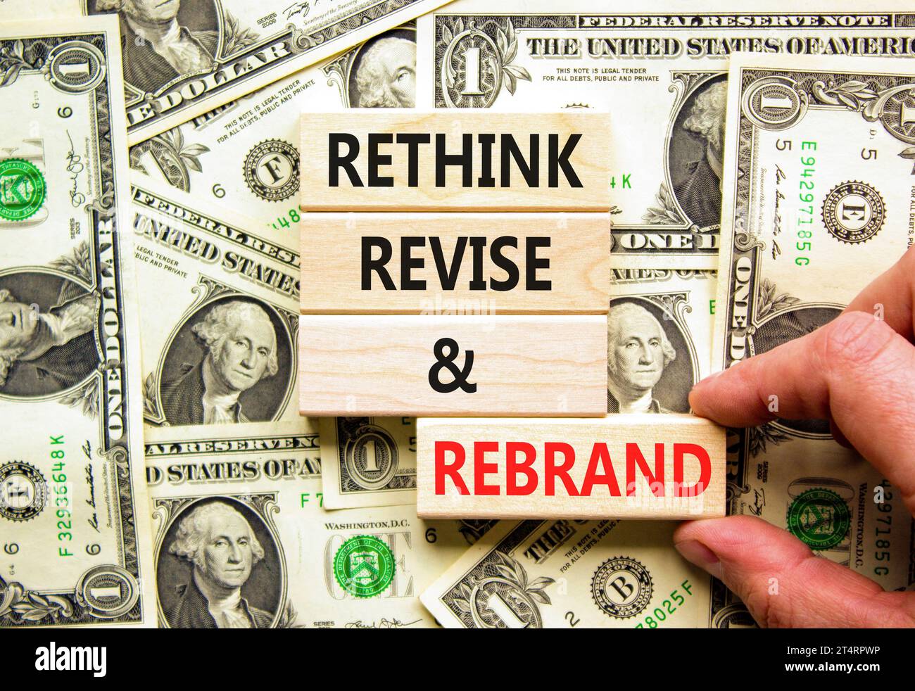 Rethink revise rebrand symbol. Concept word Rethink Revise and Rebrand on block. Dollar bills ...