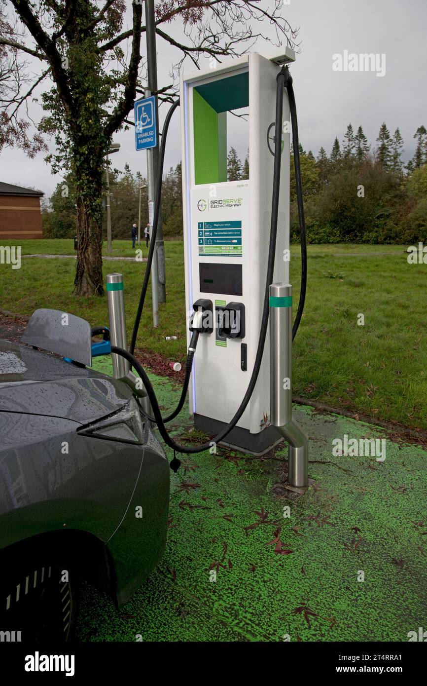 Nissan Lead electric car charging at bank of chargers in rest area of ...