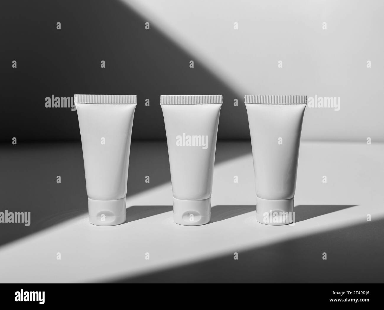 Face cream, mask tubes row, three cosmetic products mockup Stock Photo ...