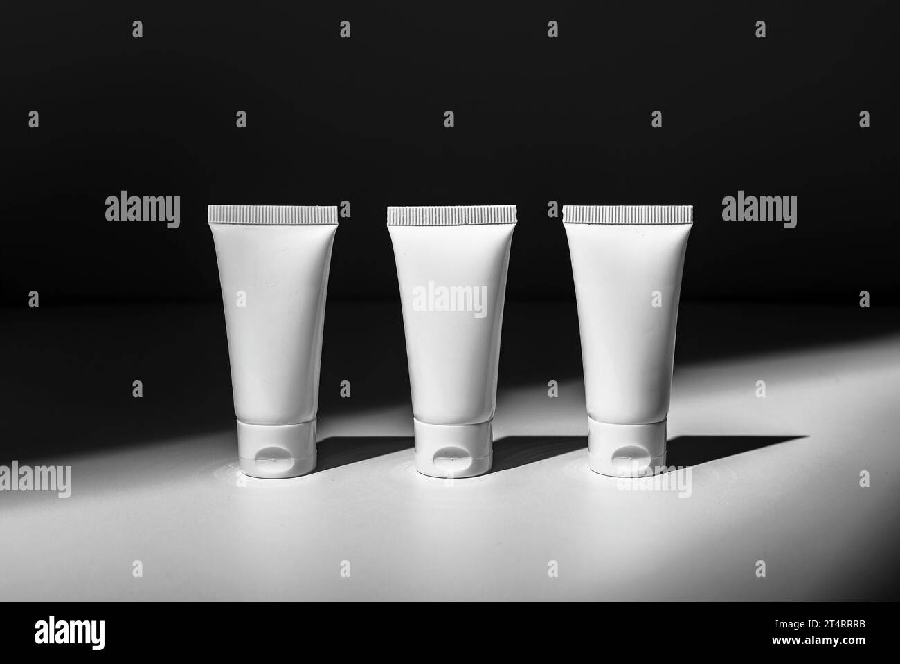Cream tubes row, three cosmetic containers, skin care products mockup ...