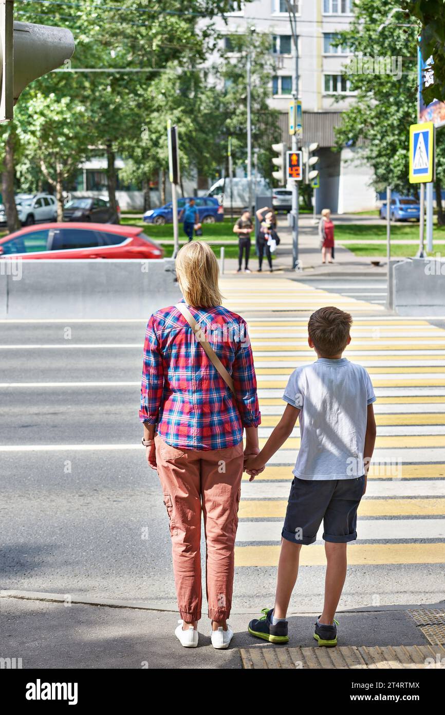Mother and child stand at the crosswalk Stock Photo - Alamy