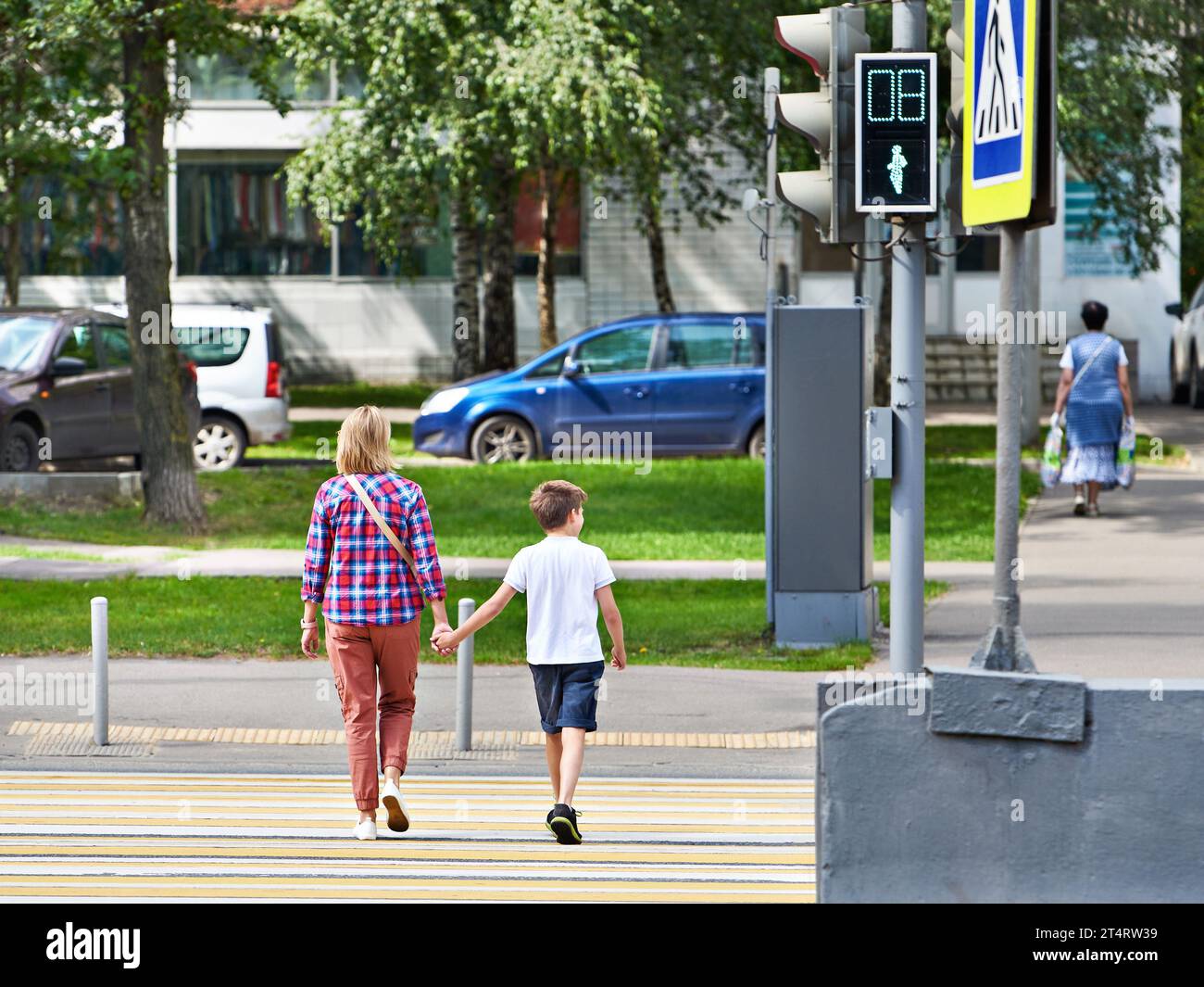 Mother and child walk on pedestrian crossing Stock Photo - Alamy