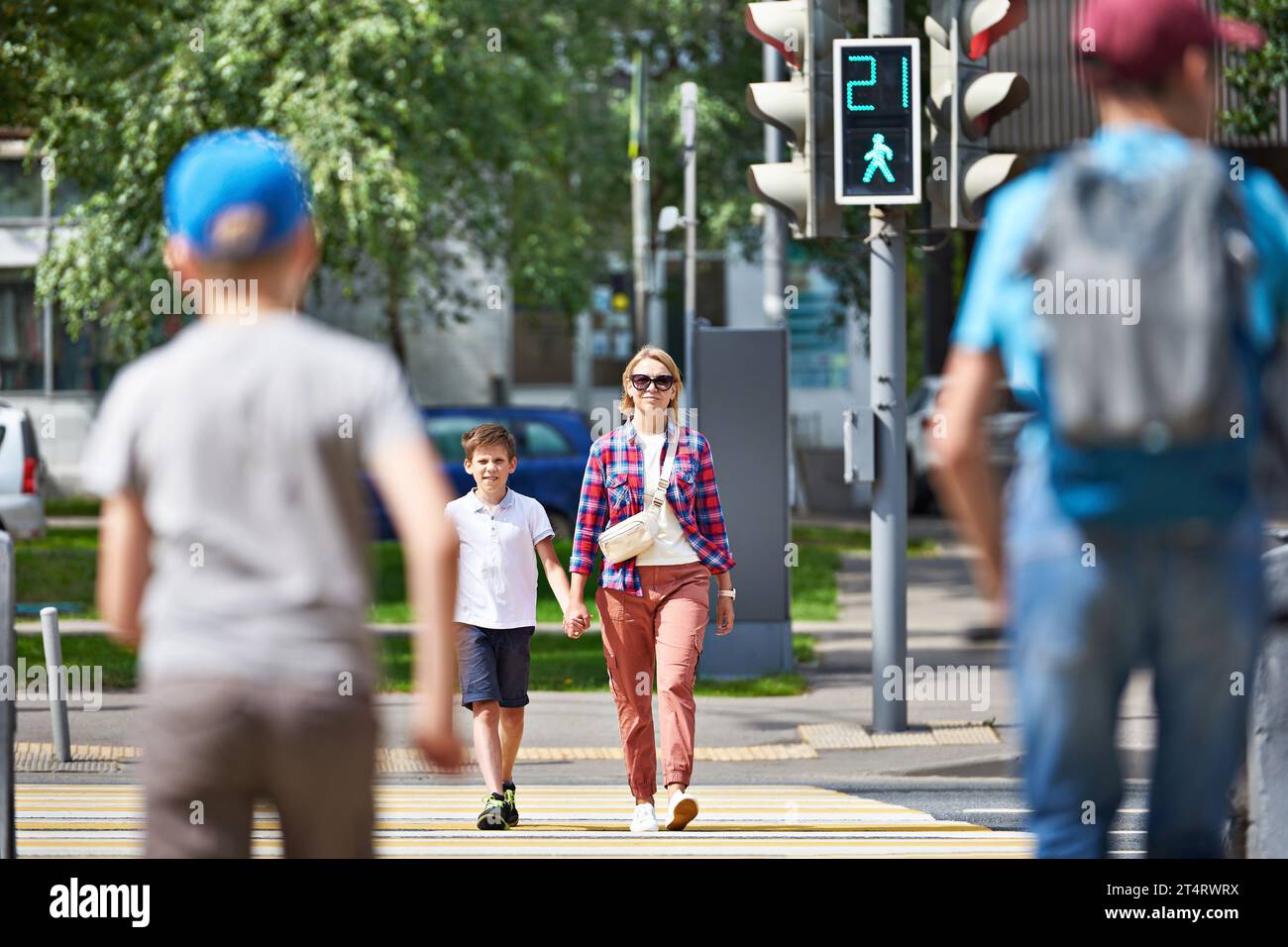 Mother and child walk on pedestrian crossing Stock Photo - Alamy