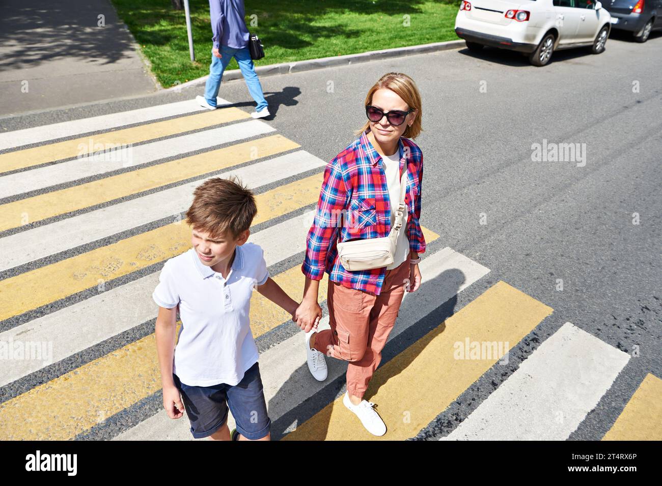Mother and child walk on pedestrian crossing Stock Photo - Alamy