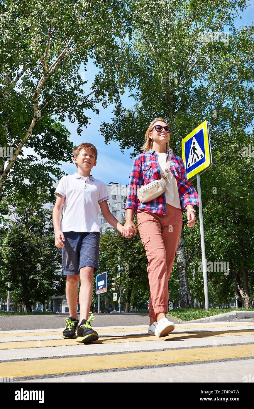 Mother and child walk on pedestrian crossing Stock Photo - Alamy
