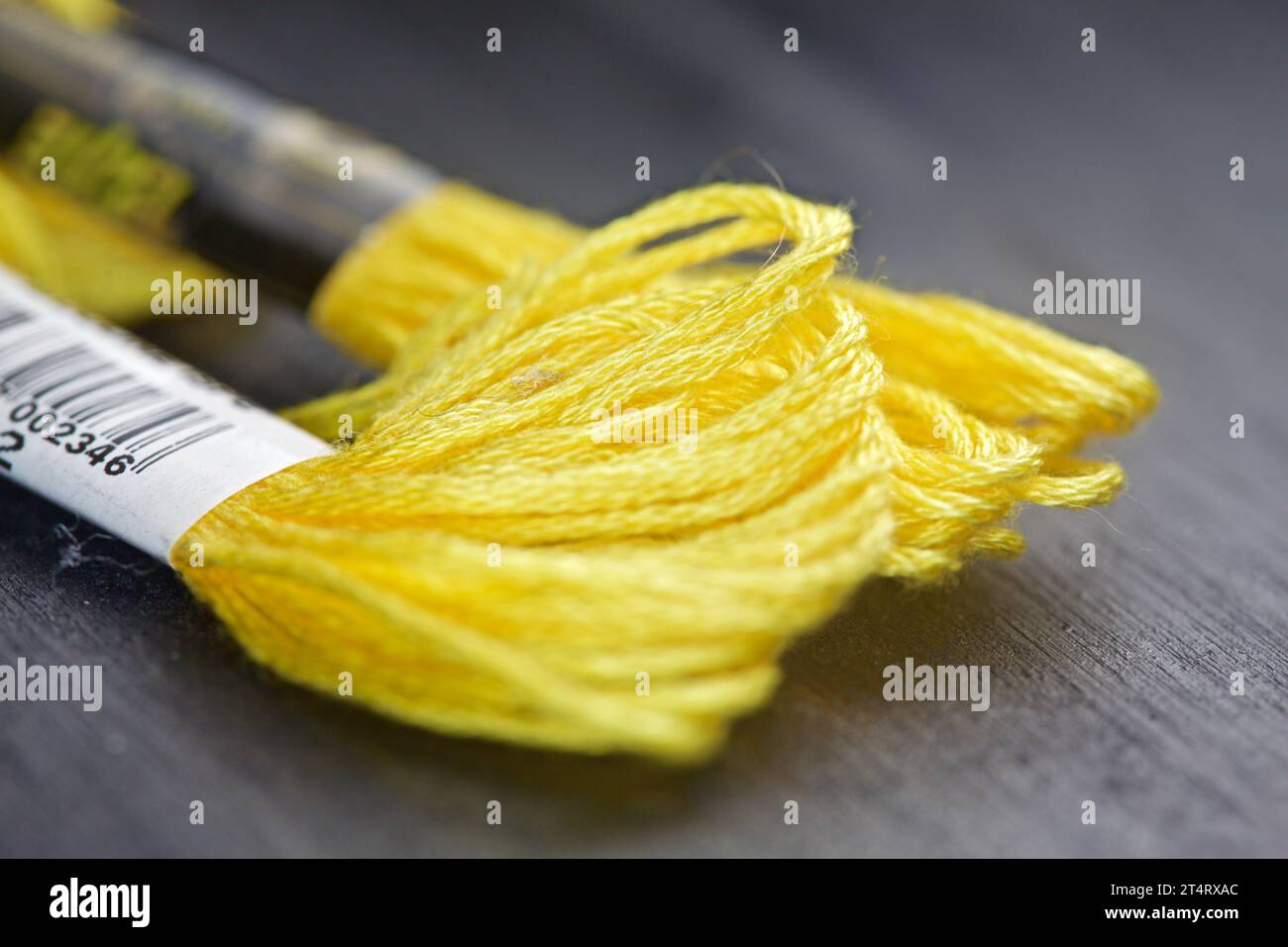 Yellow yarn on a black background seen up close Stock Photo - Alamy