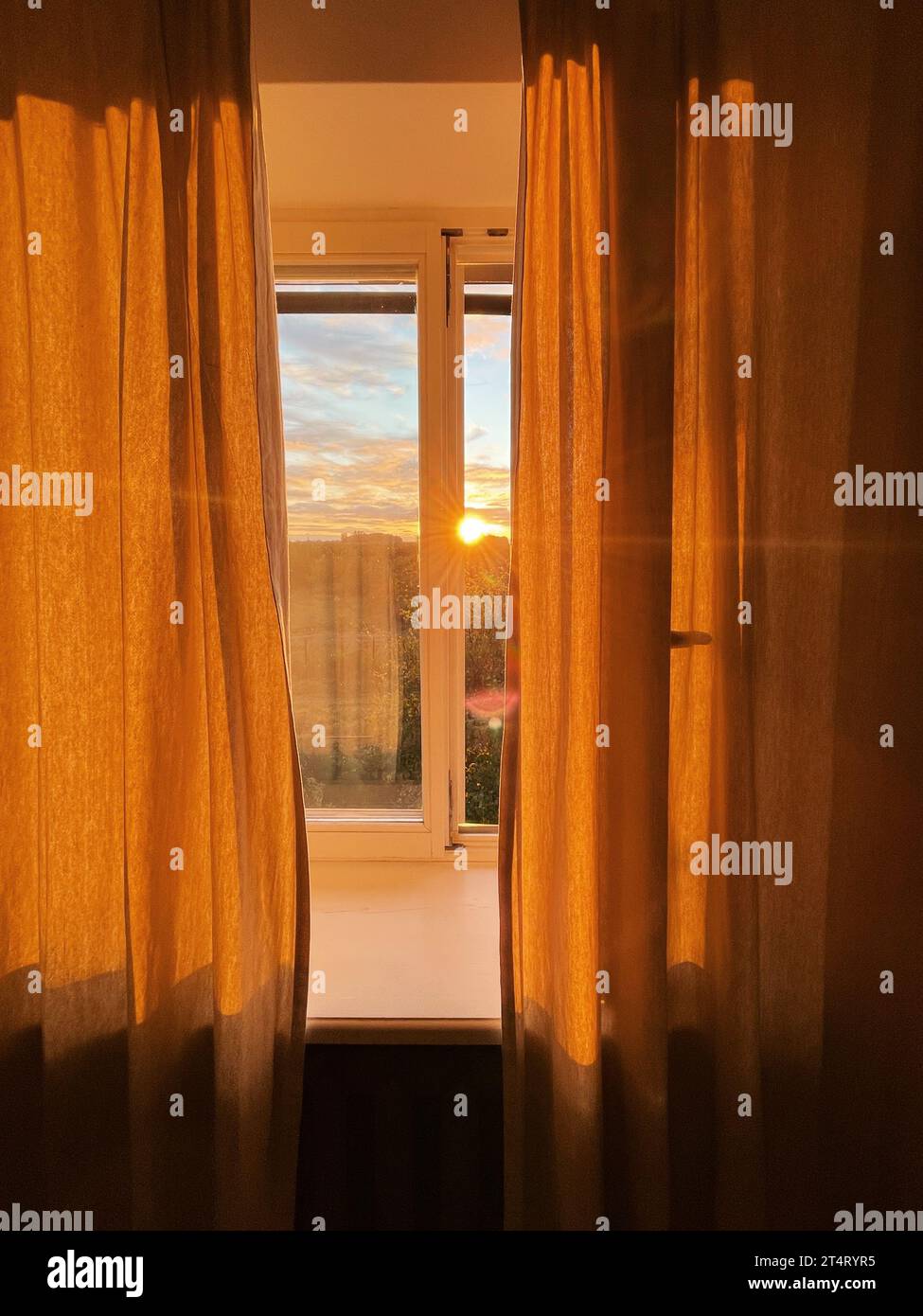 Sunrise through orange curtain hi-res stock photography and images - Alamy