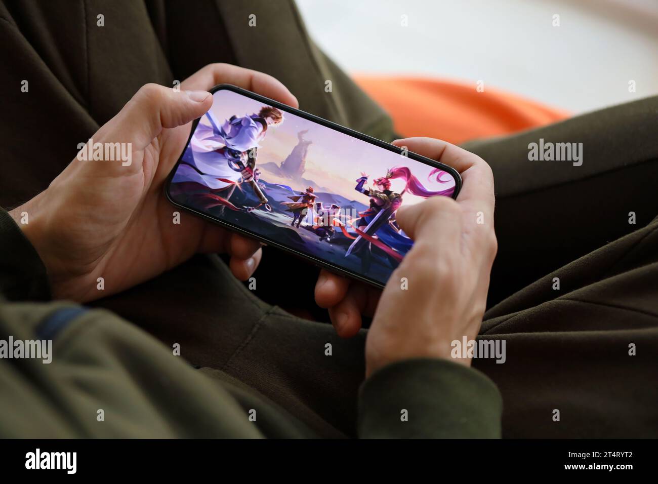 Honor of Kings mobile iOS game on iPhone 15 smartphone screen in male ...