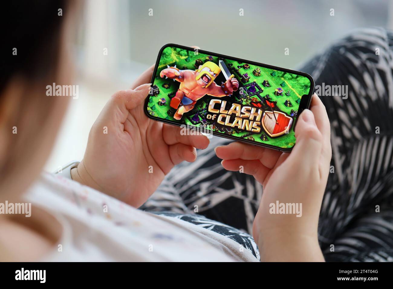 Clash of Clans mobile iOS game on iPhone 15 smartphone screen in female ...