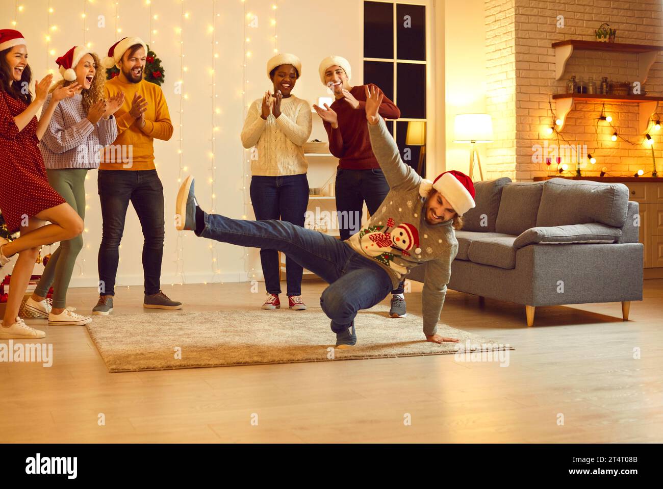 Group of happy young diverse people dancing and having fun at Christmas ...
