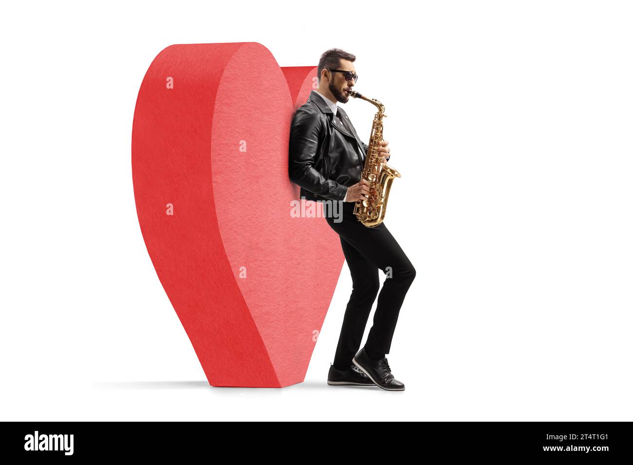 Romantic male musician in a leather jacket playing a saxophone and ...