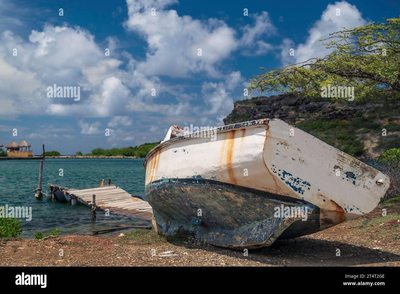 A rowing boat, on land, along the shore of an inlet, on the Caribbean ...