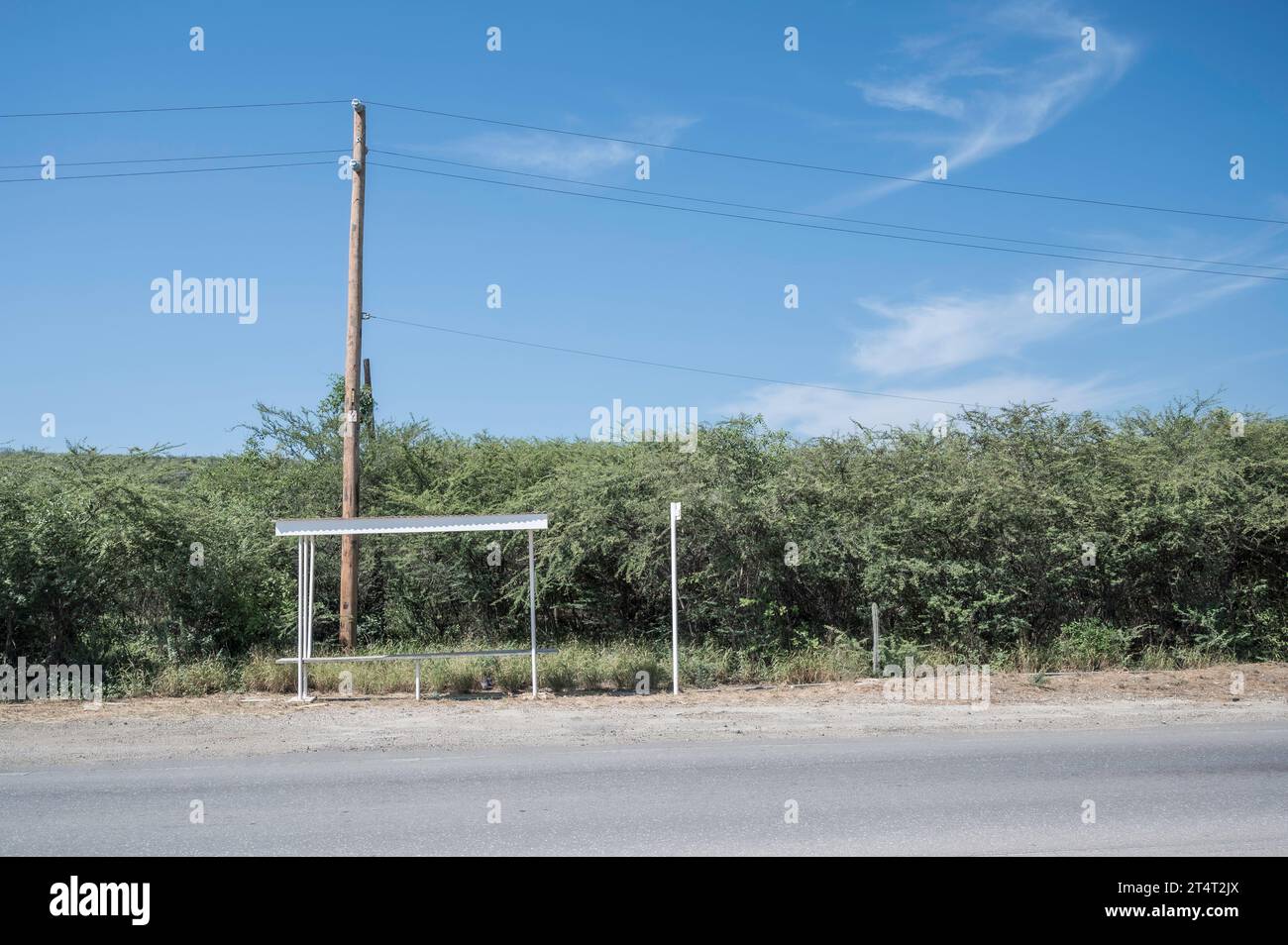 Minimal photo of a rural bus stop, on the tropical, Dutch island of ...