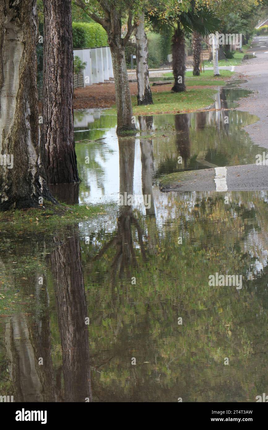 Excessive autumn rainwater creating flooding and reflections on road ...