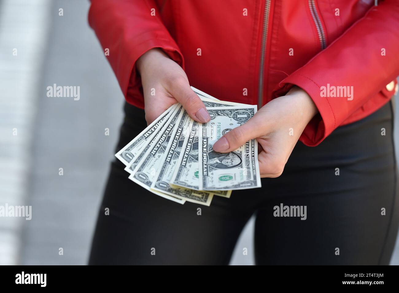 young woman hand counting one dollar bills on street Stock Photo - Alamy