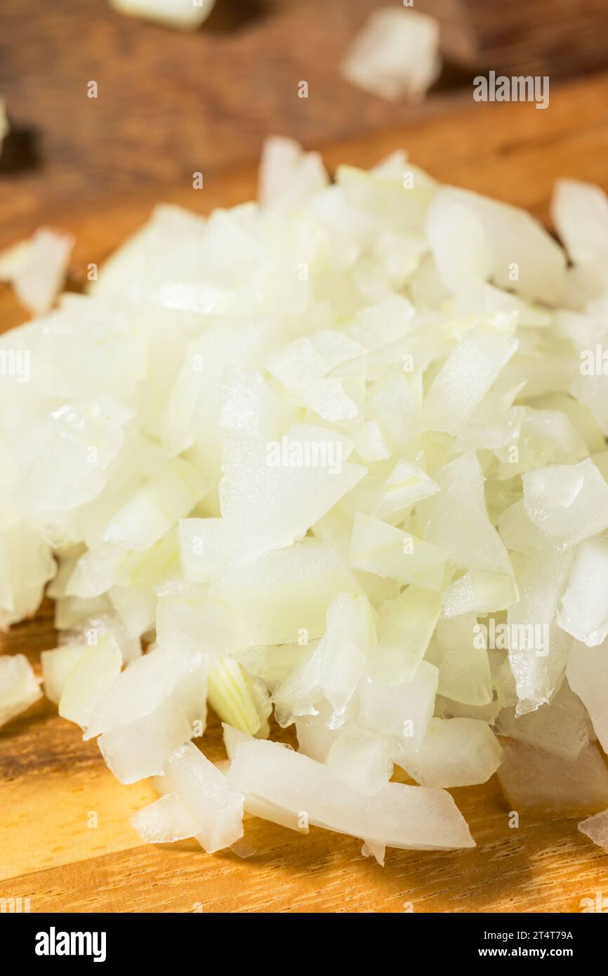 Raw Organic Yellow Diced Onions on a Cutting Board Stock Photo - Alamy