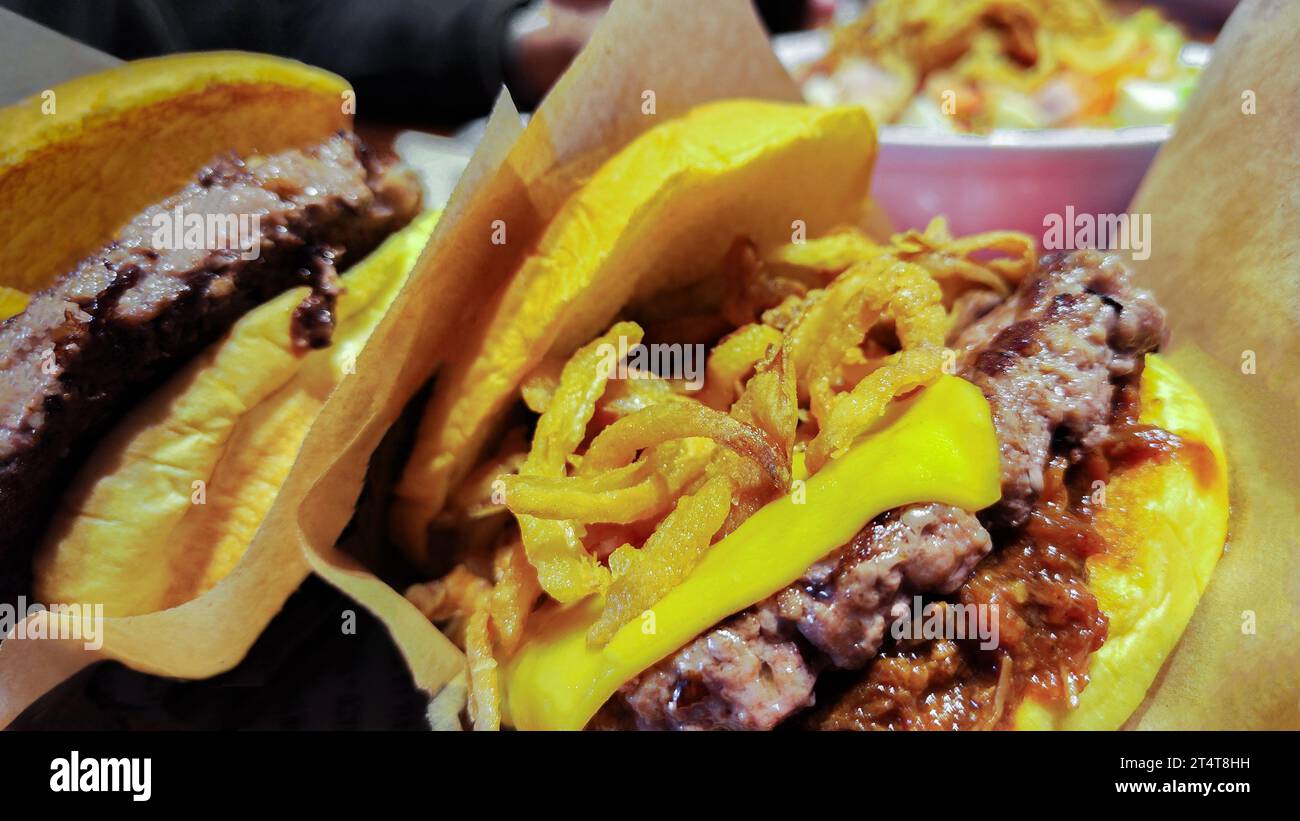 detail of a beef hamburger with barbecue sauce, cheddar cheese and ...