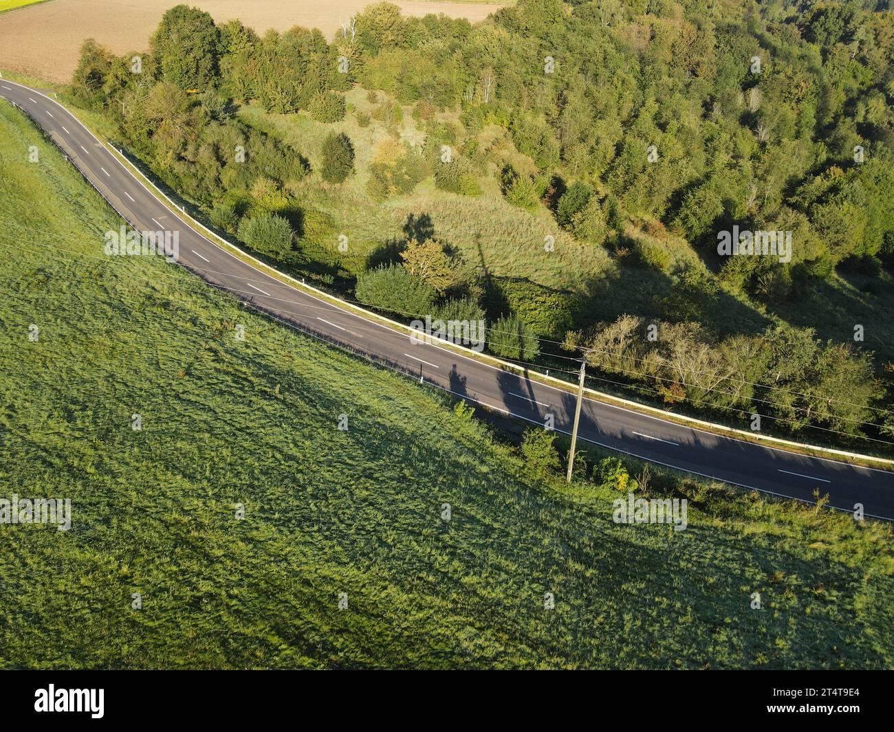Aerial view of a curved road in the landscape on a sunny morning Stock ...