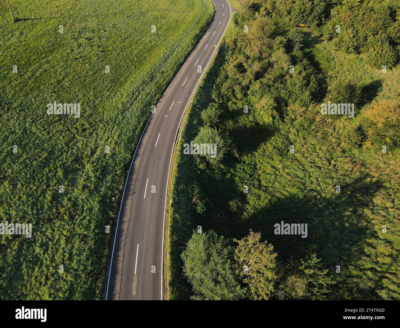 Aerial view of a curved road in the landscape on a sunny morning Stock ...