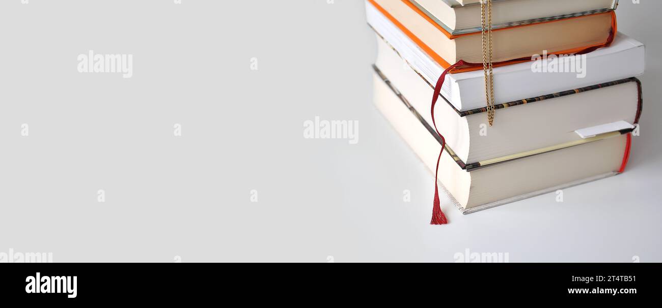 A pile of books on a light gray background. Minimal one corner ...