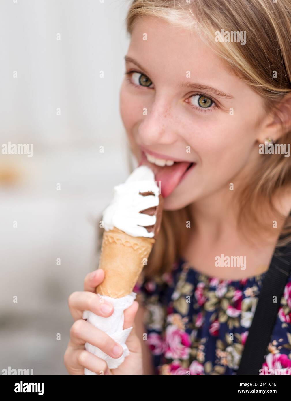 Cute little girl eating ice cream Stock Photo - Alamy