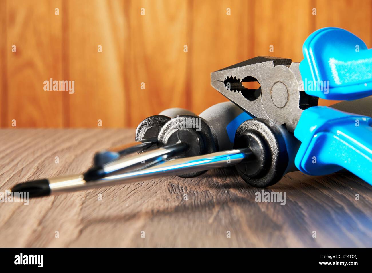 Work instruments with screwdriver and pliers on the wooden display in ...