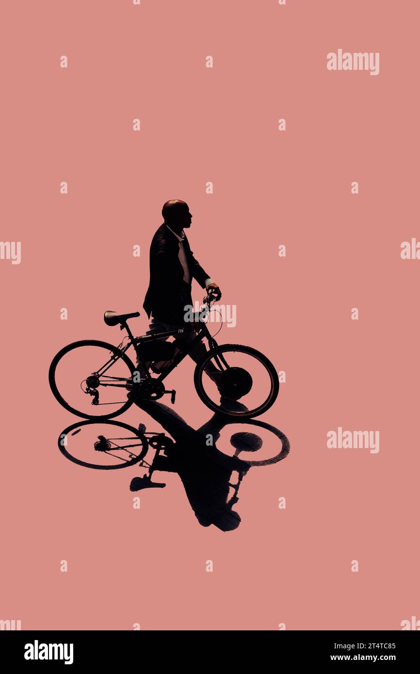 Aerial view of black male businessman pushing a bicycle in a suit on ...