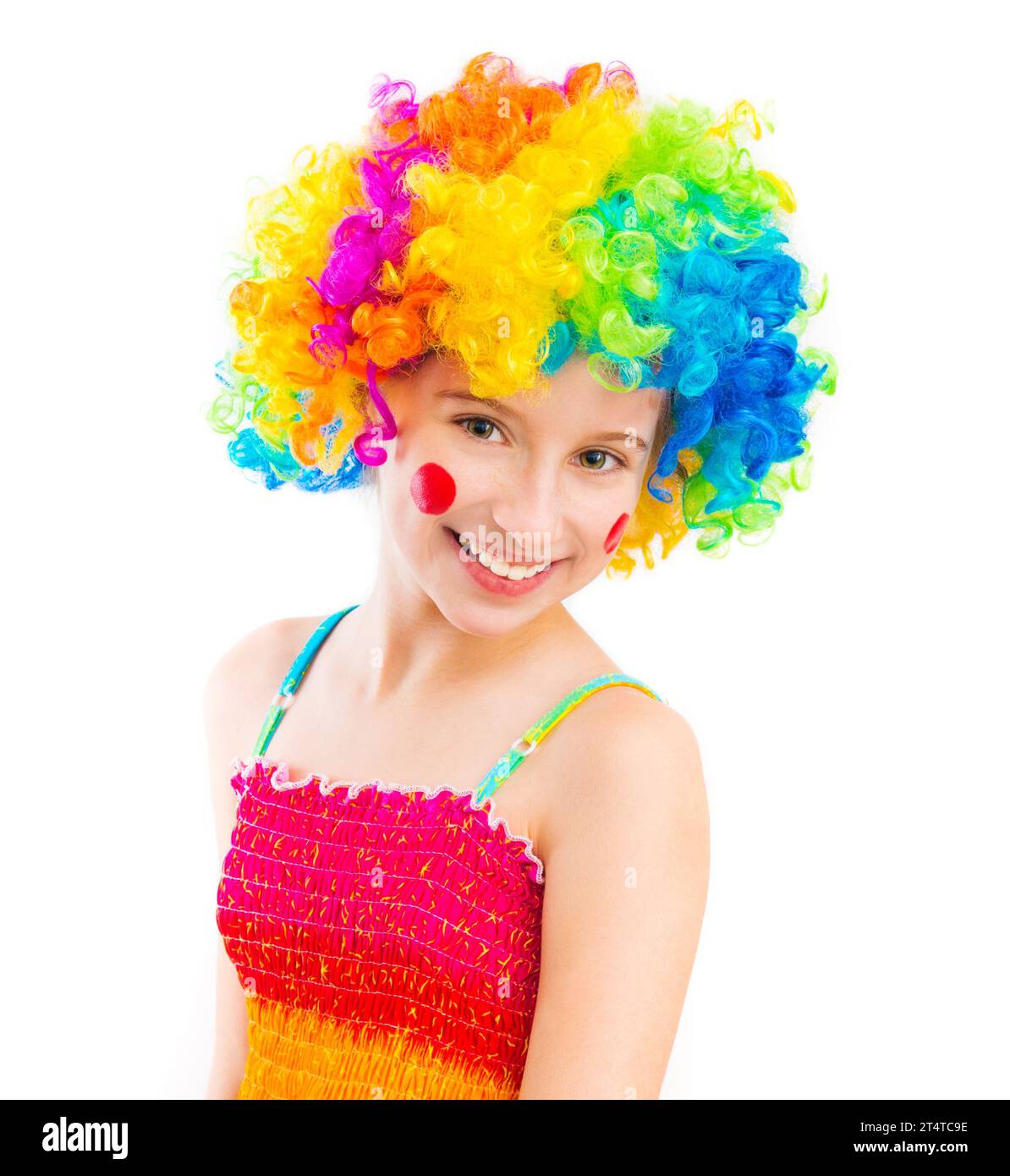 Funny little girl in clown wig with red spots on her cheeks isolated on ...