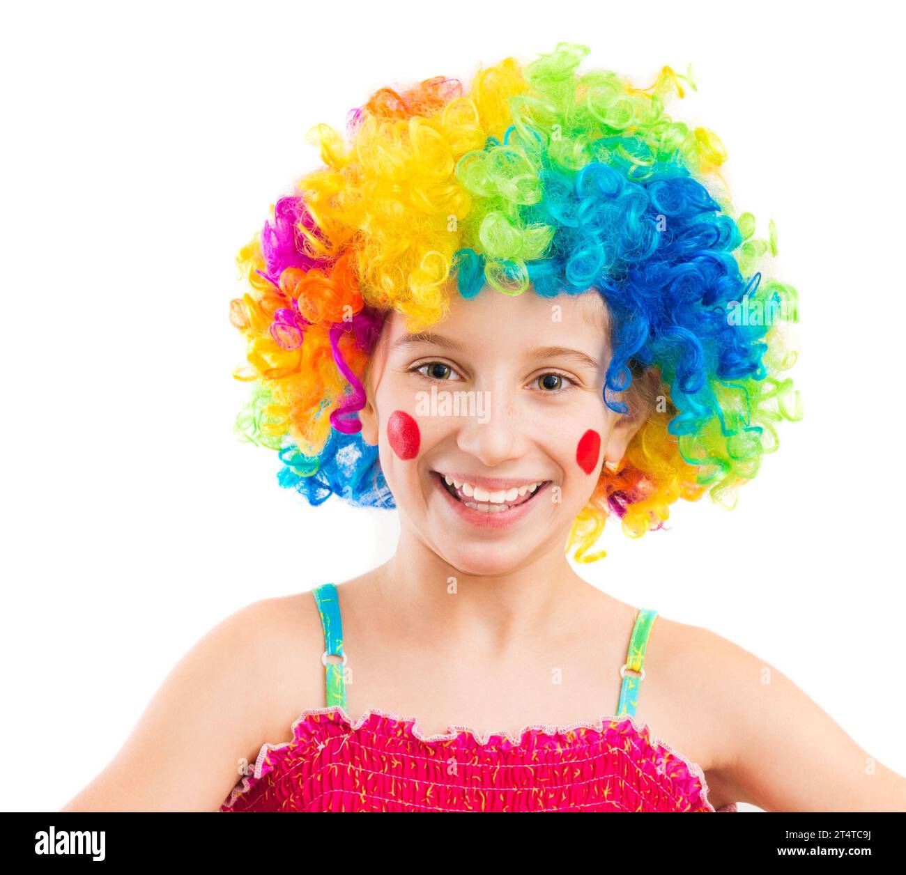 Funny little girl in clown wig with red spots on her cheeks isolated on ...