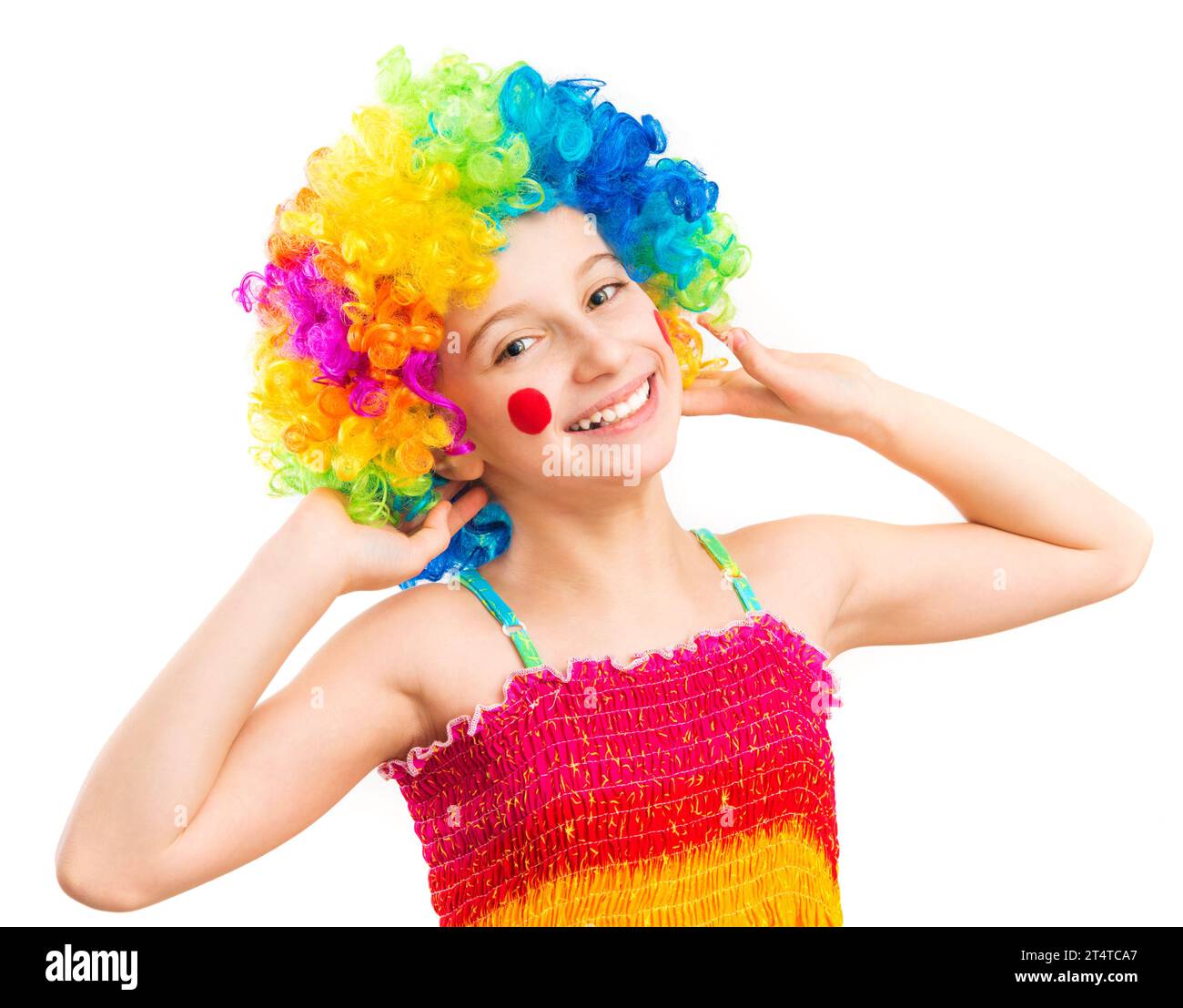 Funny little girl in clown wig with red spots on her cheeks isolated on ...