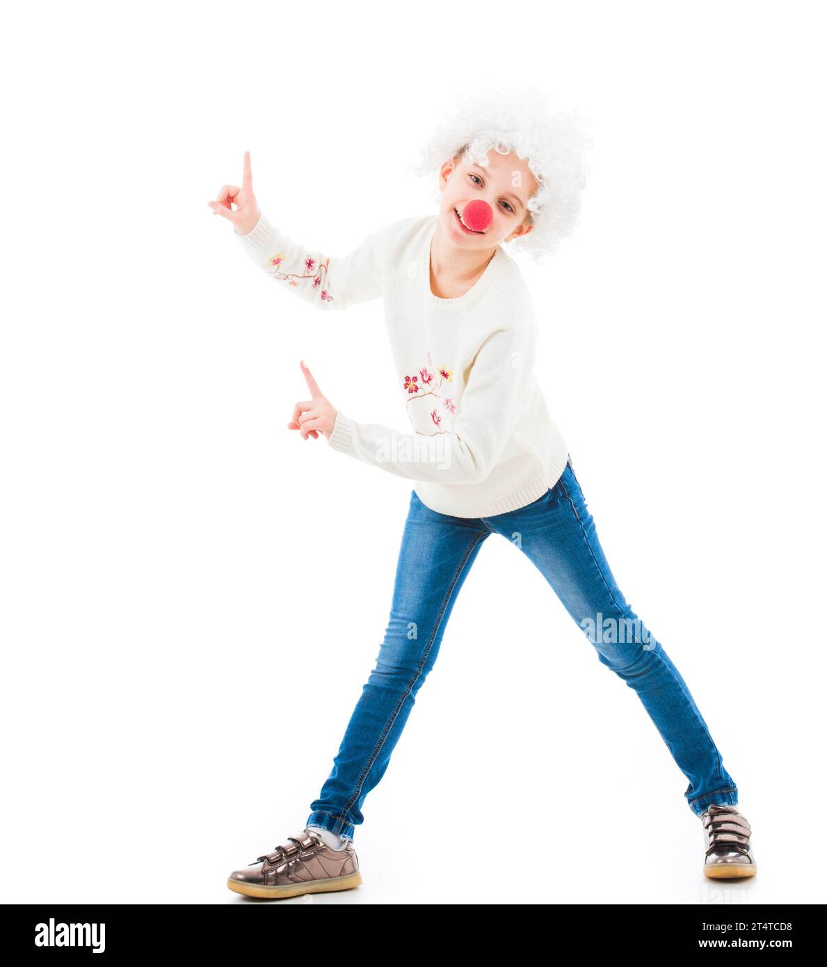 Young teenage girl in white wig and red nose pointing up with fingers ...