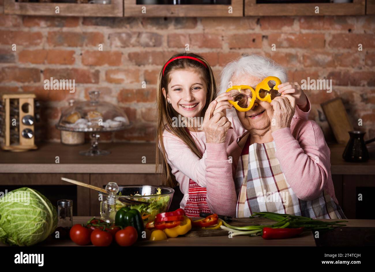 Grandchild with granny having fun while cooking at home Stock Photo - Alamy