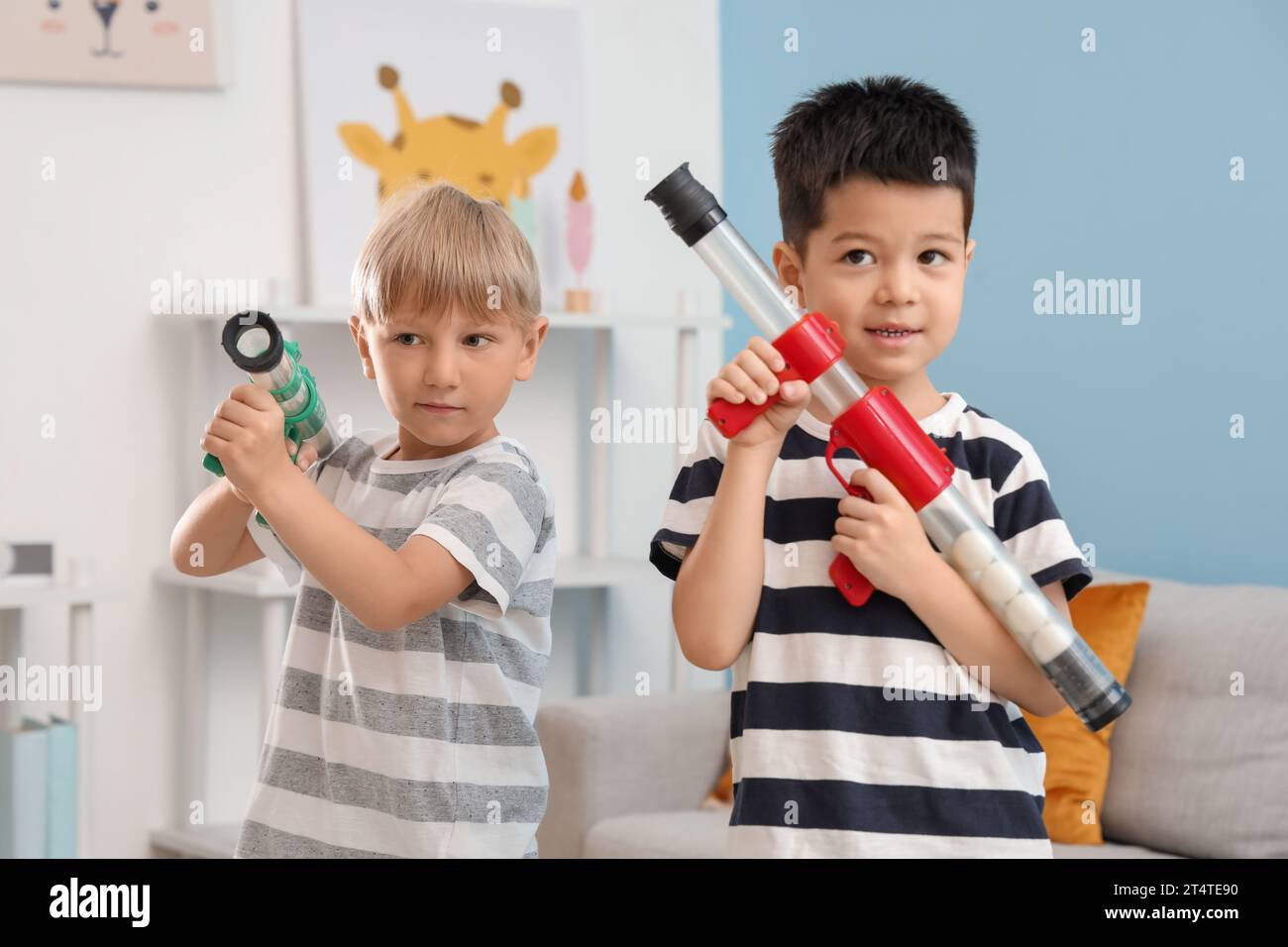 Cute little boys playing with toy guns at home Stock Photo - Alamy