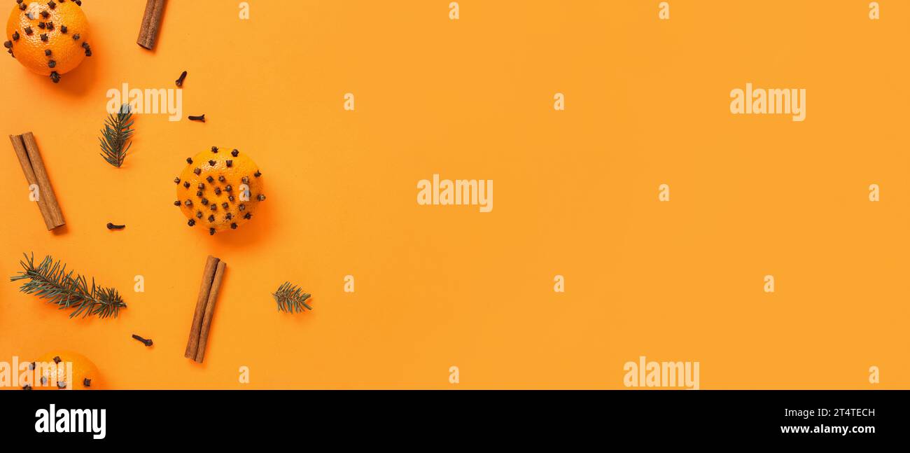 Pomander balls, Christmas tree branches and cinnamon on orange ...