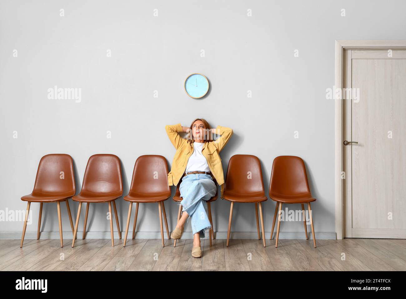 Mature woman waiting for her turn in room Stock Photo - Alamy